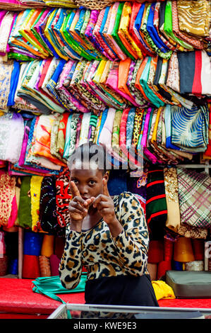 Shop assistant in an African-syle boutique, shopping mall, Kampala ...