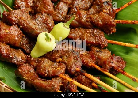 Balinese Pork Satay (Sate Babi) with rice and vegetables served in a ...