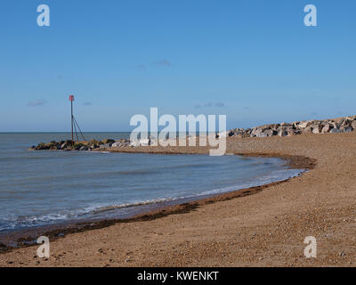 Goring-by-sea beach near Worthing, West Sussex, England, UK. Man throws ...