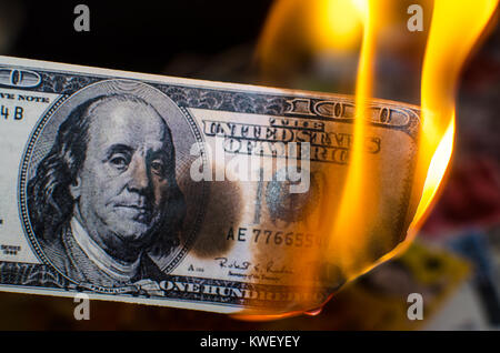 burning money US 100 dollar bill on black background Stock Photo - Alamy