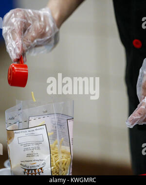 Bettendorf, Iowa, USA. 8th Dec, 2016. Advisor Angelique Kimble grabs a ...