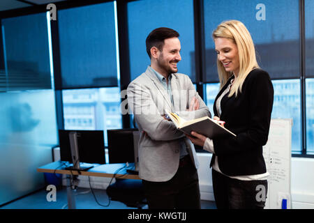Two business partners are discussing financial report with computer ...