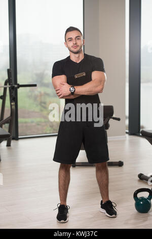 Handsome Personal Trainer With Stopwatch In A Fitness Center Gym ...
