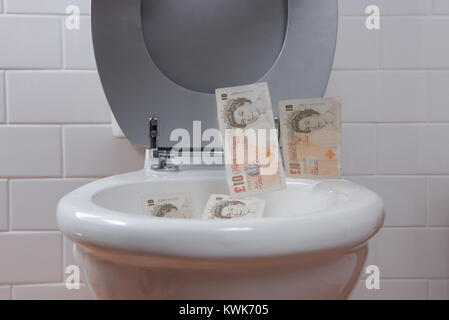 flushing money down a toilet Stock Photo - Alamy