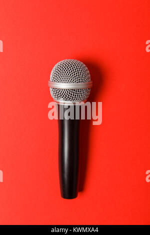 microphone on a bright red background Stock Photo - Alamy