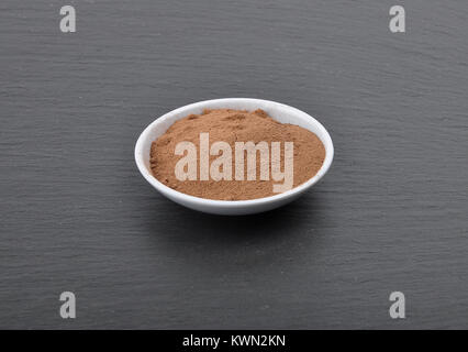 Bowl with cocoa powder on shale Stock Photo - Alamy