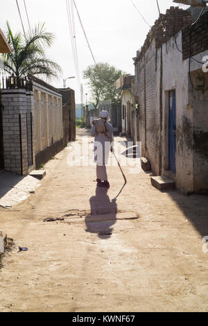 Rear view of an old Pakistani man walking in an alley Stock Photo - Alamy