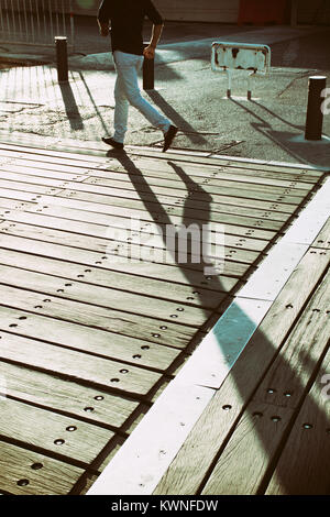 Mysterious male figure running away outdoors Stock Photo - Alamy