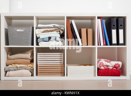 white rack with shelves full of stuff Stock Photo - Alamy