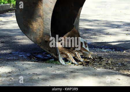 the tractor rests against a defect on the asphalt Stock Photo - Alamy