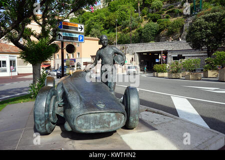 Bronze statue of Juan Manuel Fangio standing alongside his grand prix ...