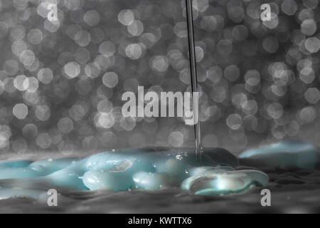 Falling drops or streams of wax on melted wax Stock Photo - Alamy
