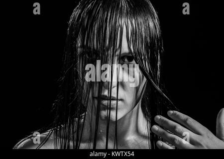 serious angry woman with wet black hair looking at camera Stock Photo ...