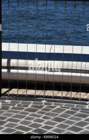 DIscarded Straw underneath a railing Stock Photo - Alamy
