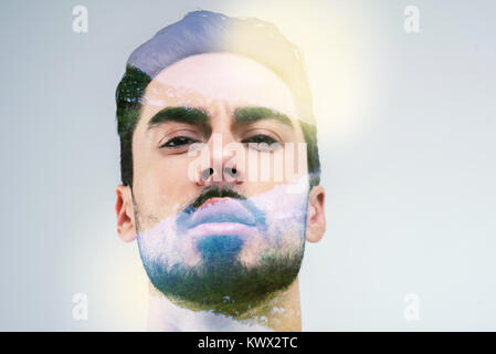 Image of a handsome thinking young bearded man standing isolated over ...