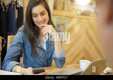 Active woman meeting client at coffee shop Stock Photo - Alamy