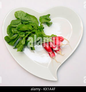 bunch of radishes on heart shape plate, heathy food Stock Photo - Alamy