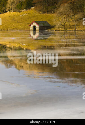 Frozen tarn on winter afternoon with grand view of dramatic Lake ...