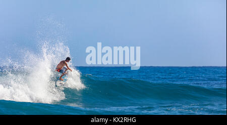 A male surfer executes a radical move on a beautiful ocean wave Stock ...