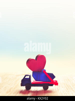 Red retro car with a heart in a winter landscape. Postcard for ...