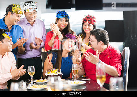 Happy exuberant group of friends celebrating a birthday party toasting ...