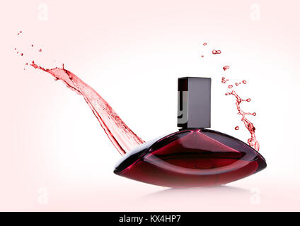 Luxury pink red liquid perfume bottle with splashes on pink background ...