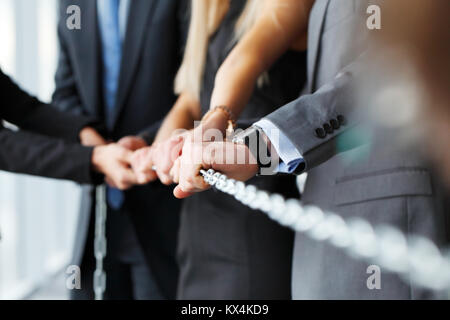 Businessmen pulling chain, teamwork togetherness concept Stock Photo ...