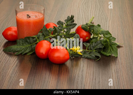 Red tomato on the table. Many tomatoes on wooden table. Locally grown ...