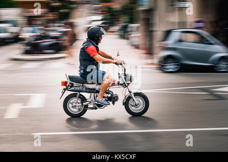 man riding mini motorcycle Stock Photo - Alamy