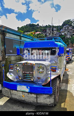 A blue Public Utility Jeepney Vehicle being driven in Olongapo City ...