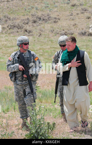 Afghan national army soldier serves the volleyball during a game held ...