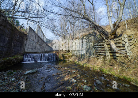 Abandoned Japanese concrete strengthening of a soil slope. Sakhalin ...