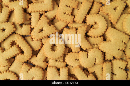 Cookies alphabet close-up. A pile of biscuits with English letters ...