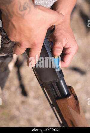 Hunter loading his rifle Stock Photo - Alamy