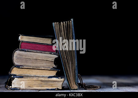 Old destroyed books on a wooden table. Reading room library with very ...
