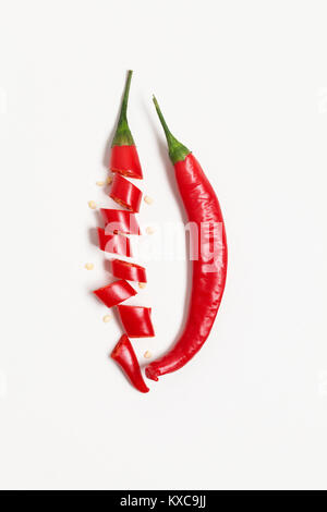 Sliced red chili pepper arranged on a bright red background Stock Photo ...