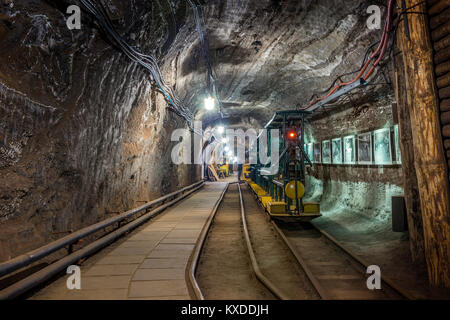 Yellow passenger underground train used in an old salt mine to ...