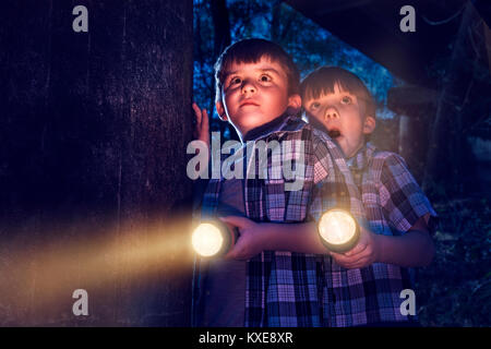 Young boys scared in dark with flashlight Stock Photo - Alamy