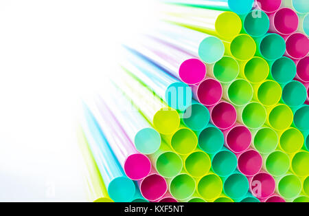 Many colorful straws stacked on top of each other of pyramid. Beyond ...