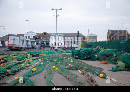 Fishing nets spread out in the shallow water by the shore Stock Photo ...