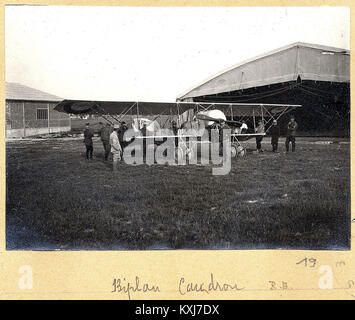 This photograph shows an aircraft, specifically a biplane, on the deck ...