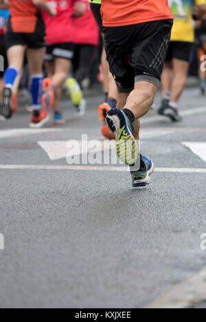 Athlete runner legs from behind with sporty clothes during the racing ...