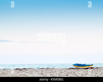 Djerba, Tunisia, beach with sea and colorful fishing boat, cloudy ...