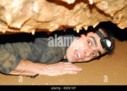 Cave exploration, exploring a cavern. Narrow path in caves and caverns ...