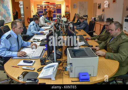 Polish police officers and border patrols stand in front of the ...