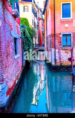 Colorful small canal bridge, boats reflections, Venice, Italy Stock ...