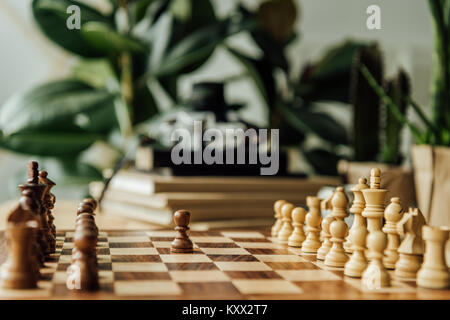 Side view of Chess board ready for the game on the room close to window ...