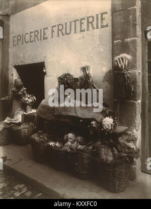 Photograph by Eugène Atget depicting a Parisian ragpicker standing in a ...