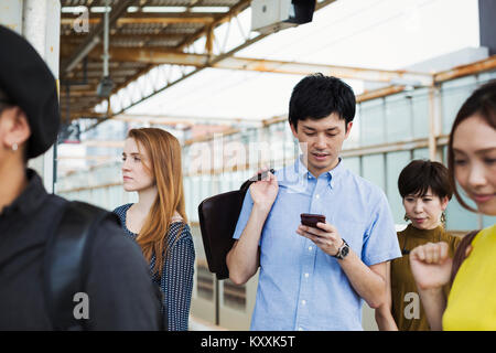 Japanese mobile telephone use by commuters and public in Tokyo, Japan ...