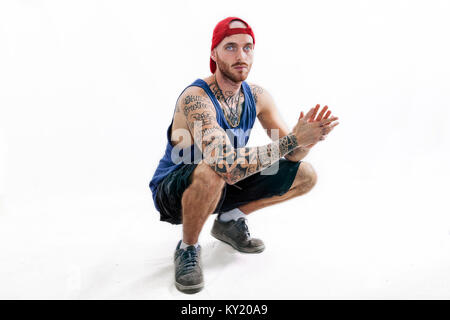 sitting tattooed rap singer posing in studio with expressive position ...